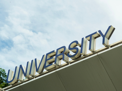 University,Letter,Signage,Over,The,Cloudy,Sky,Background. – Total ...
